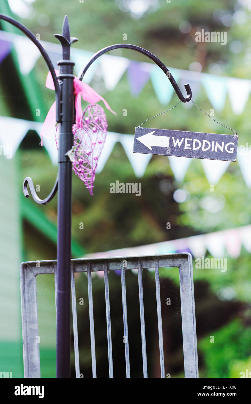 A decorative retro sign points in the direction of a wedding Stock ...