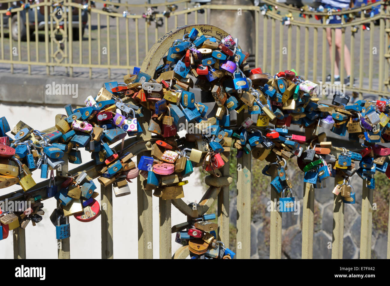 Closed padlocks of all sizes on the railings of a bridge as a symbolic ...