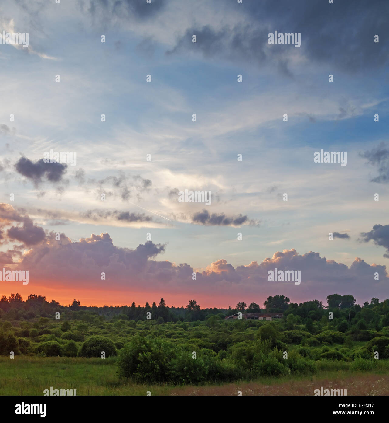 Sunset over village Stock Photo - Alamy
