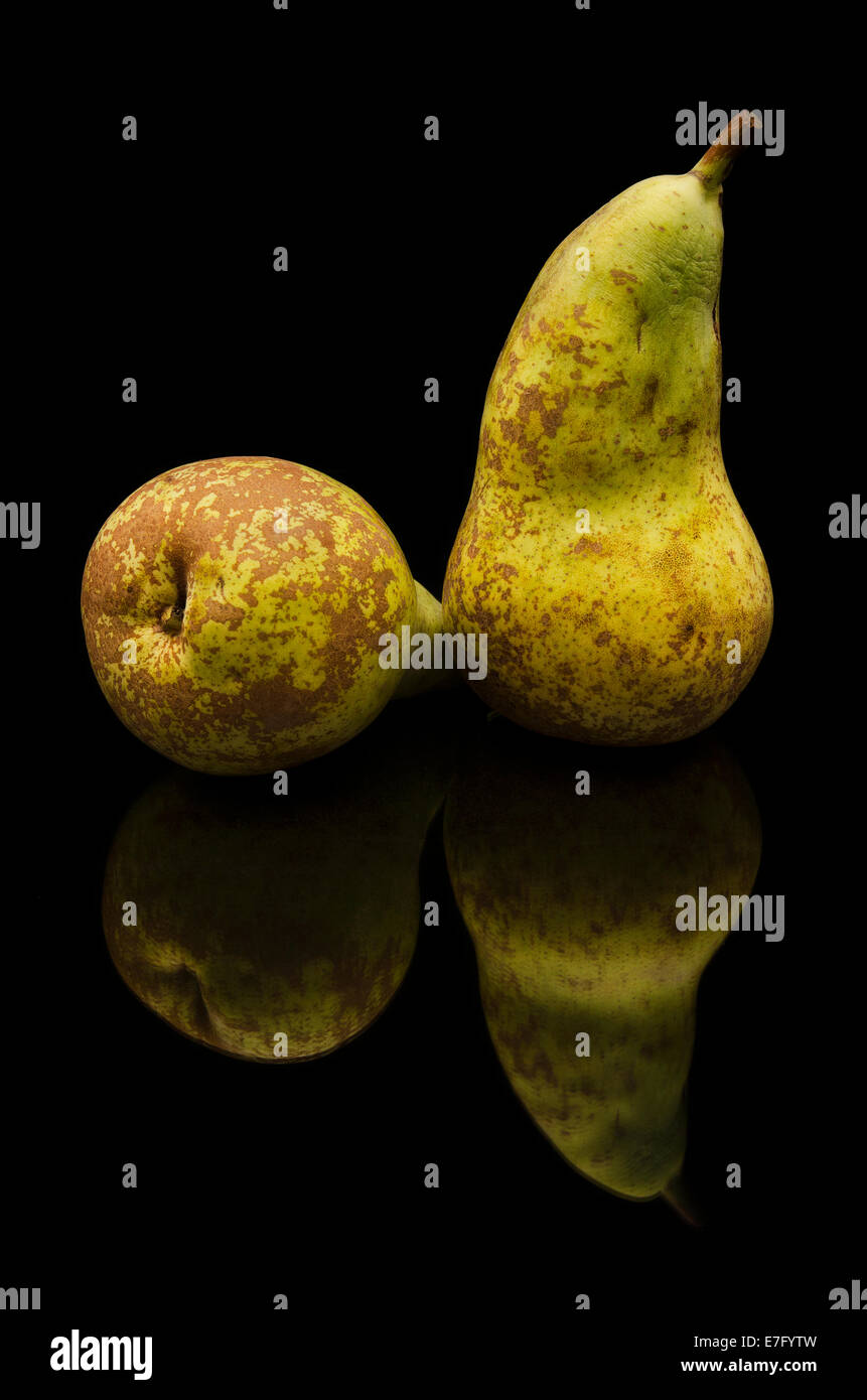 Brown pears on black isolated background Stock Photo - Alamy