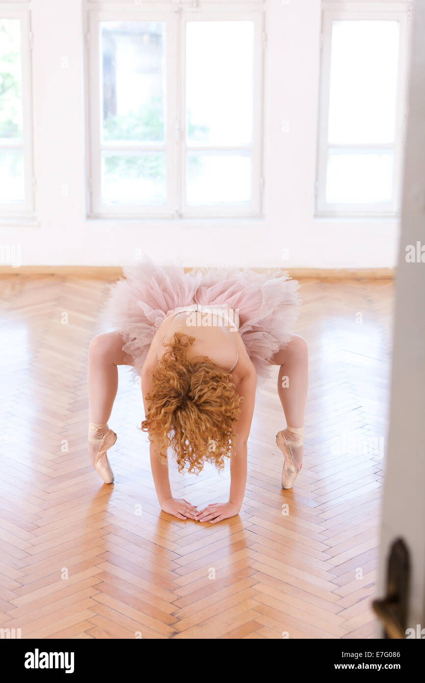 Ballerina performing a difficult position. Large copy space composition ...
