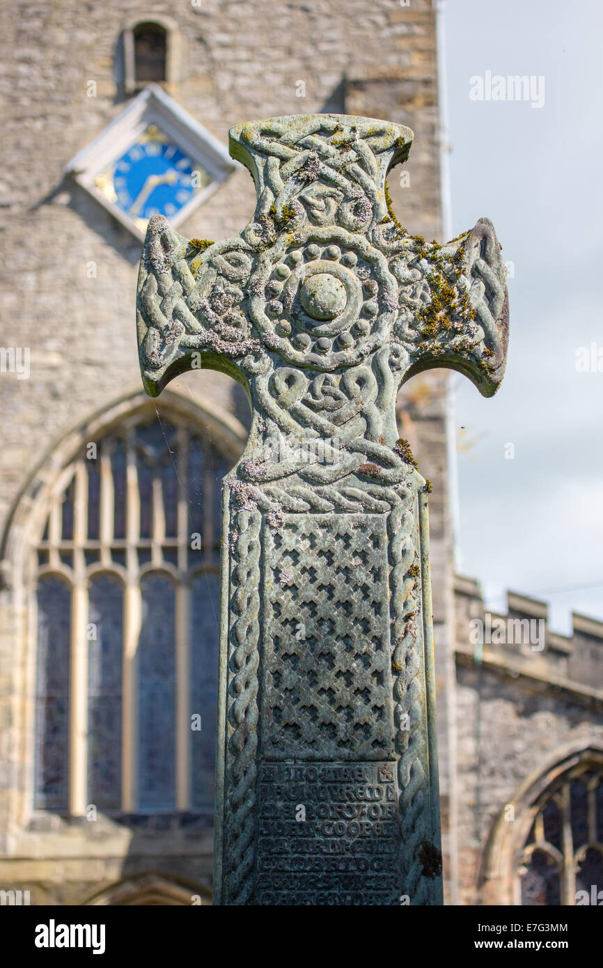 A carved stone cross in the grounds of Kendal Parish Church in Cumbria ...