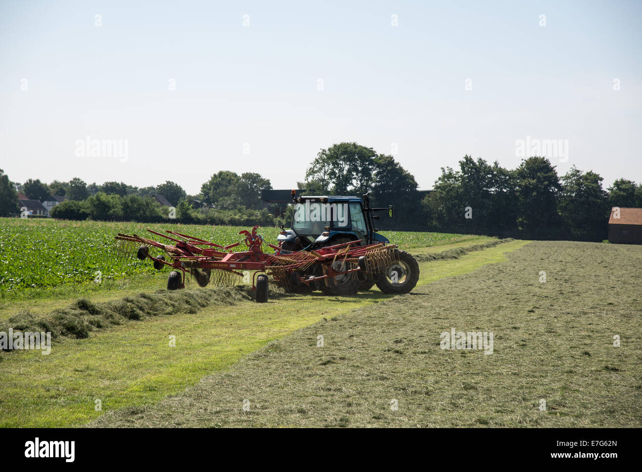 farmer harvesting with a tractor Stock Photo - Alamy