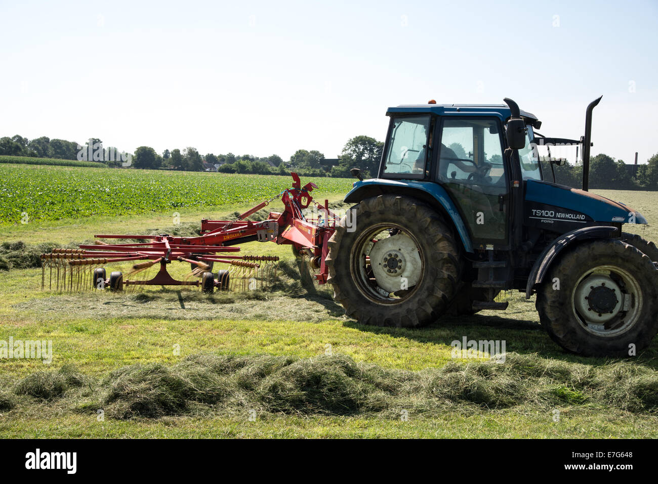 farmer harvesting with a tractor Stock Photo - Alamy