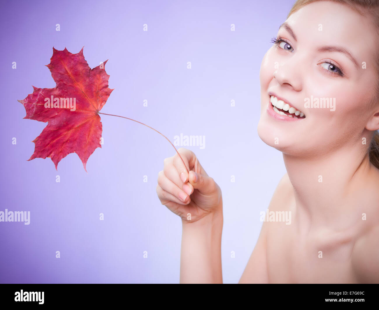 Skin care. Face of young woman girl with red maple leaf Stock Photo - Alamy