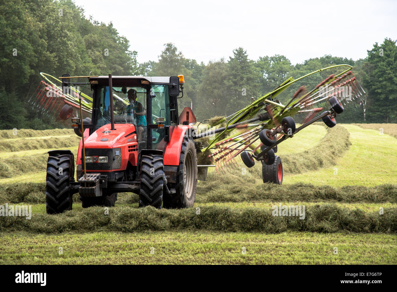 farmer harvesting with a tractor Stock Photo - Alamy