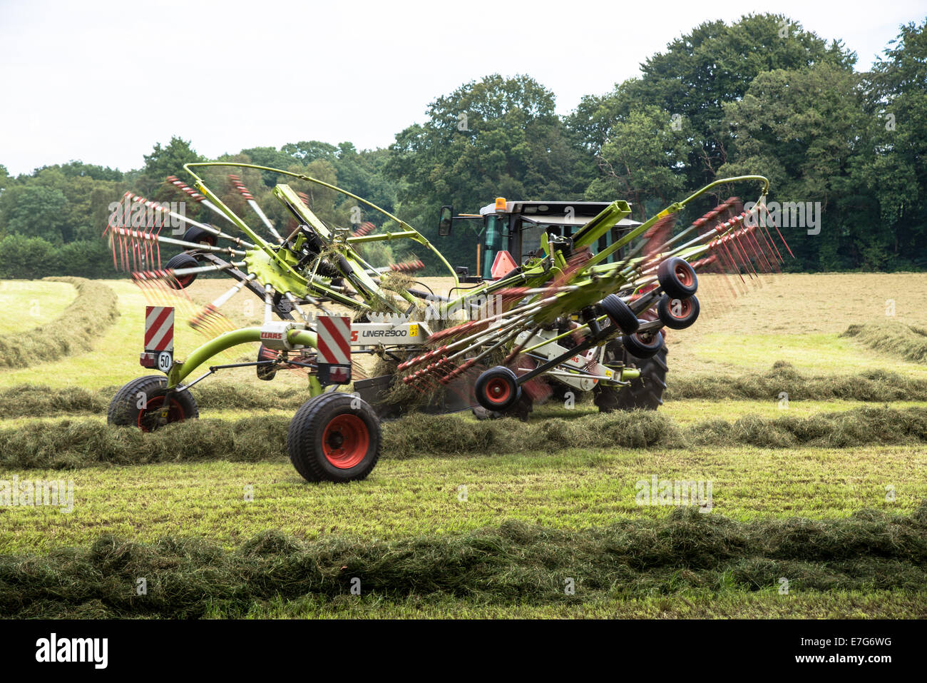 farmer harvesting with a tractor Stock Photo - Alamy