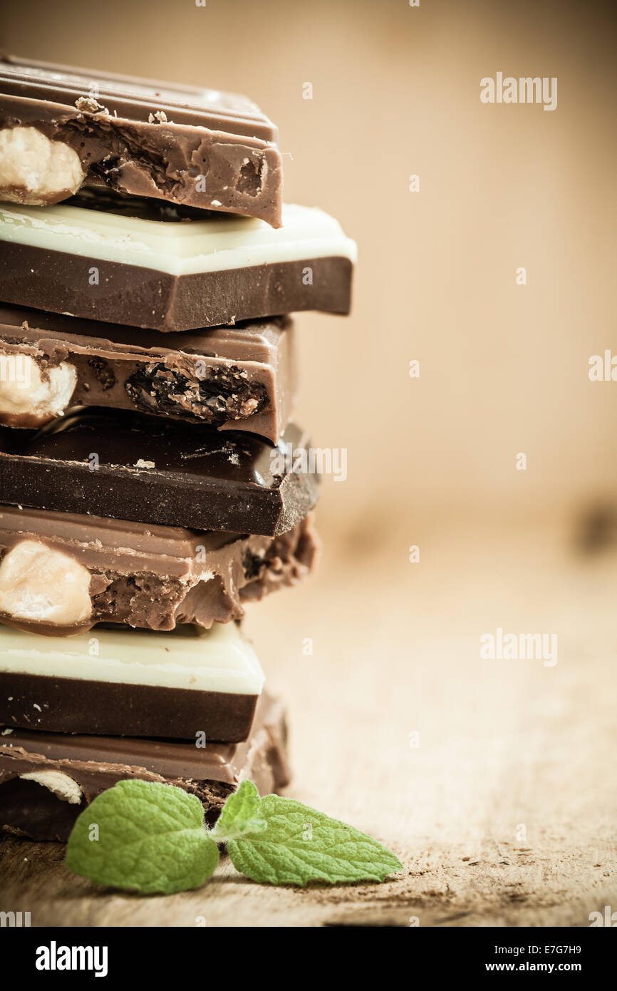 Closeup stack of different sorts chocolate pieces. Variety of ...
