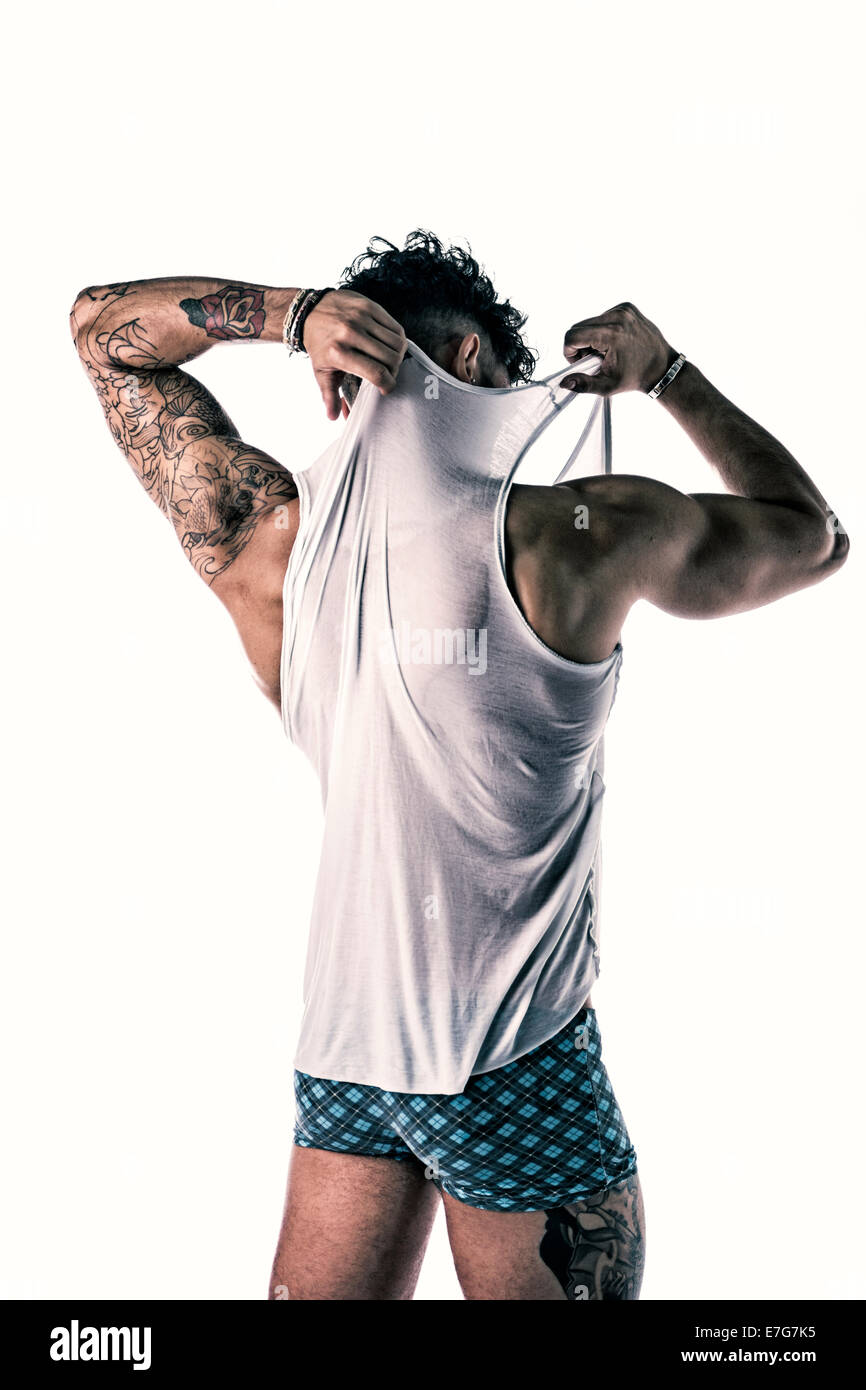 Back of strong and healthy young man posing in tank top isolated on ...