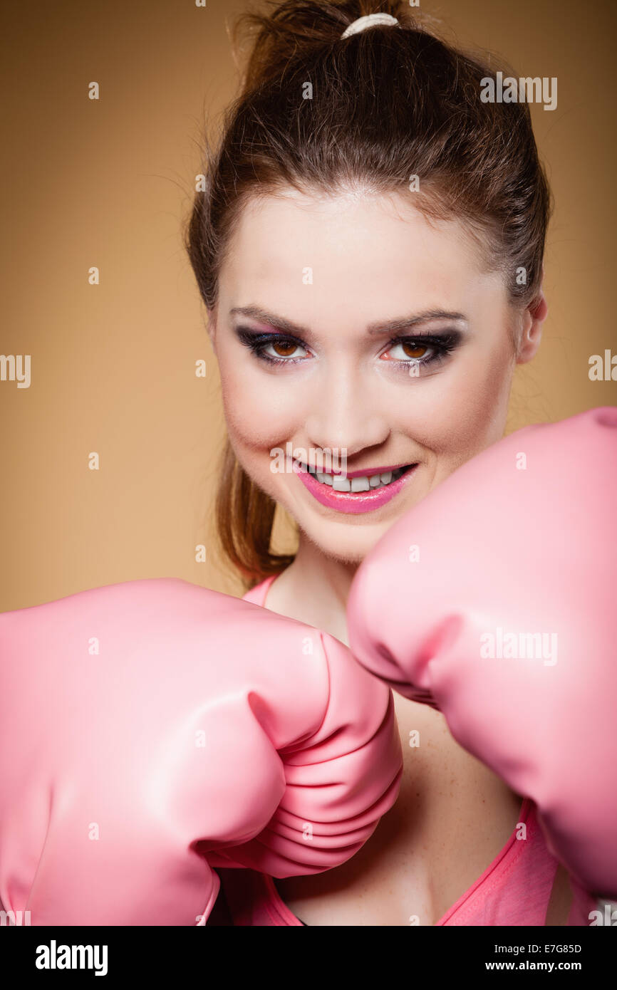 Sporty woman female boxer model wearing big fun pink gloves playing ...