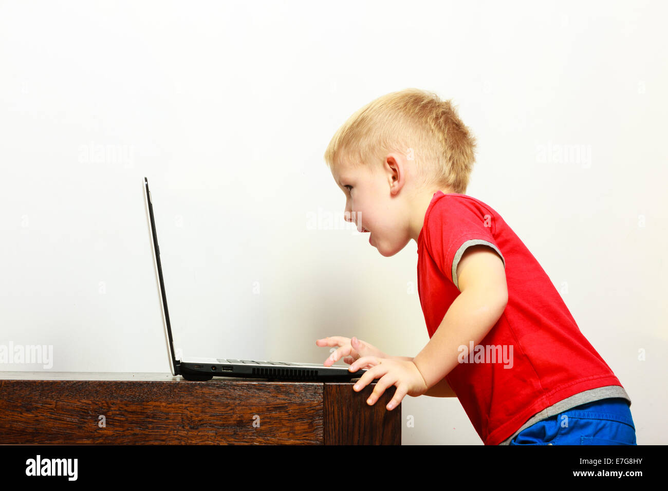 Children, technology and home concept - little boy kid child using ...