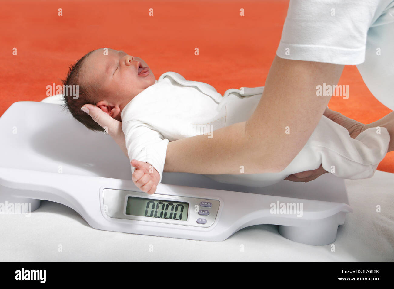 baby boy on weight scale Stock Photo - Alamy