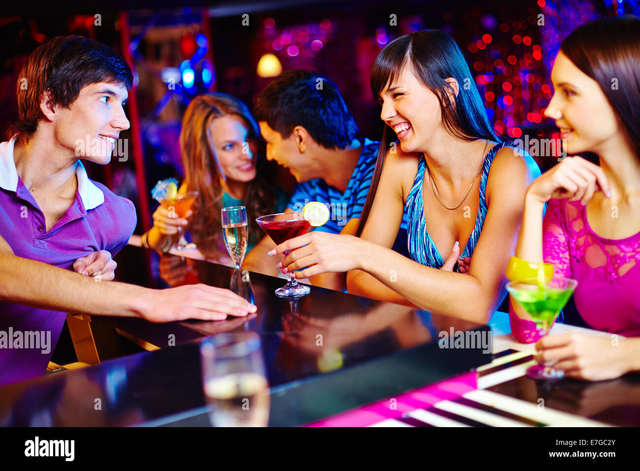 Portrait of joyful friends talking at party in the bar Stock Photo - Alamy
