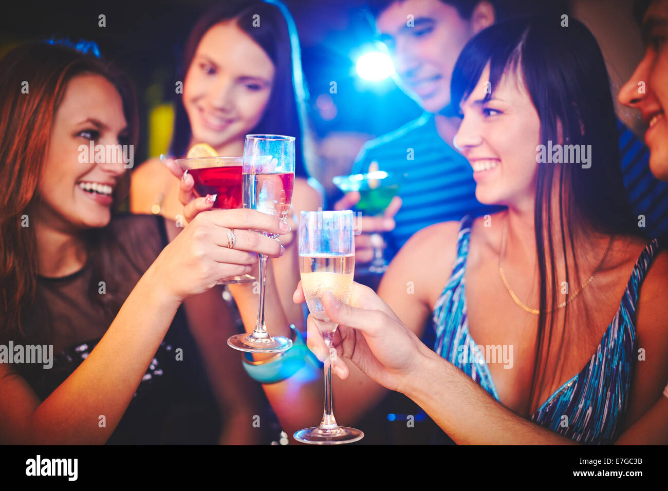 Happy girls and guys toasting at party Stock Photo - Alamy
