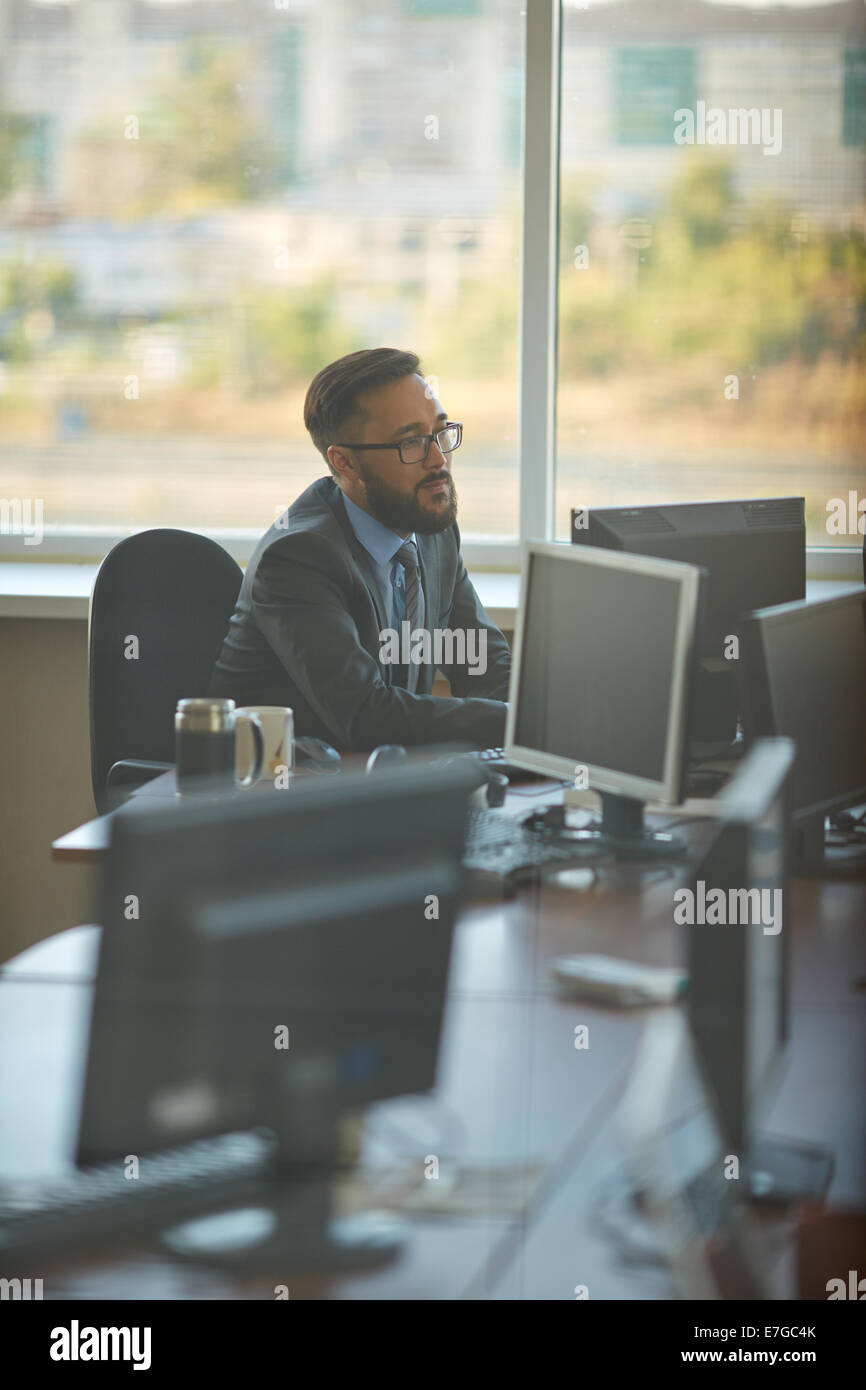 Busy Asian manager working with computer in office Stock Photo - Alamy