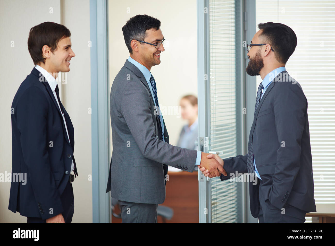 Two businessmen handshaking in office after signing contract Stock ...