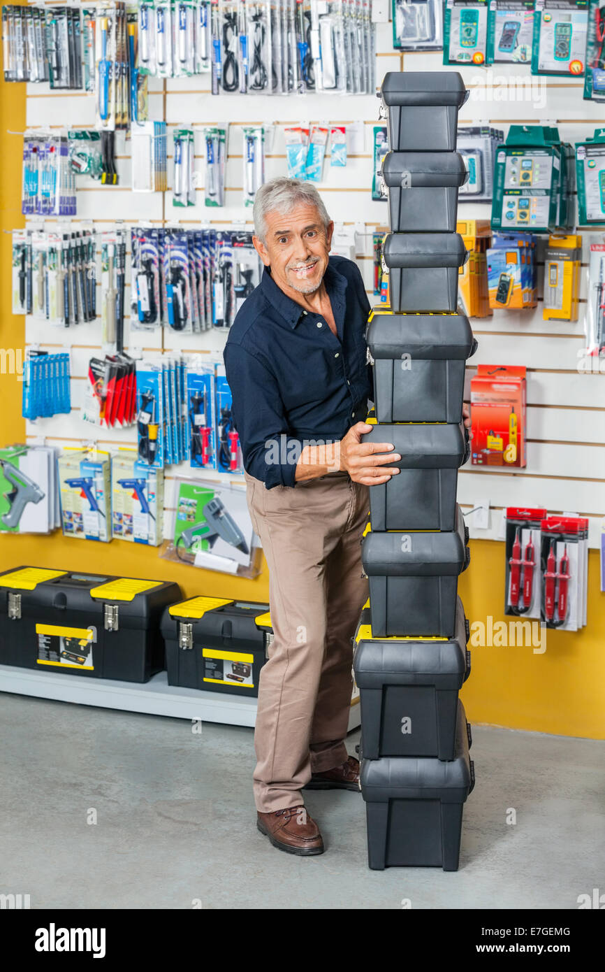 Man Stacking Toolboxes In Hardware Store Stock Photo - Alamy