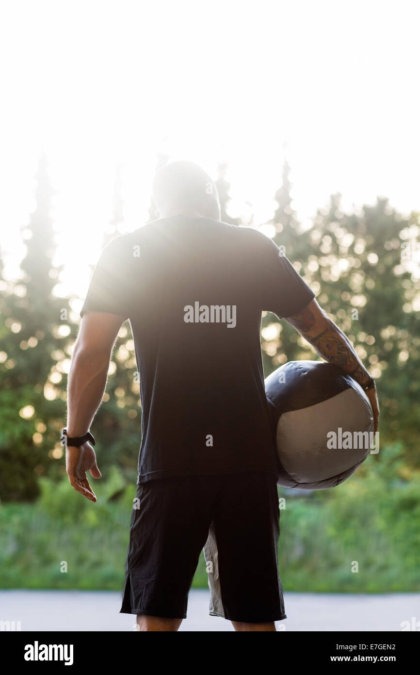 Fit Man Carrying Medicine Ball Stock Photo - Alamy