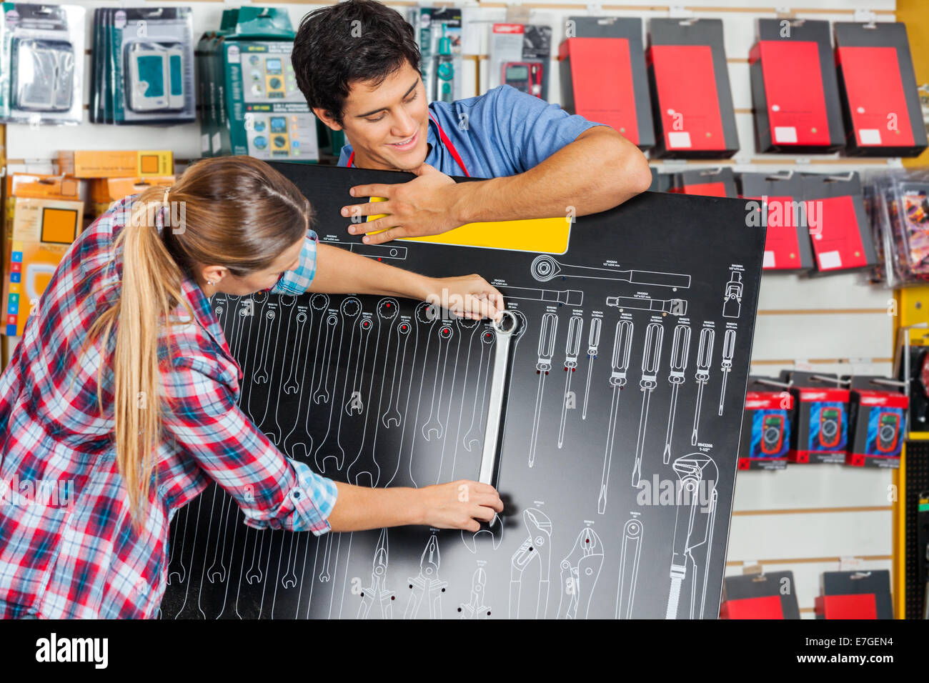 Customer Examining Wrench Using Board In Store Stock Photo - Alamy