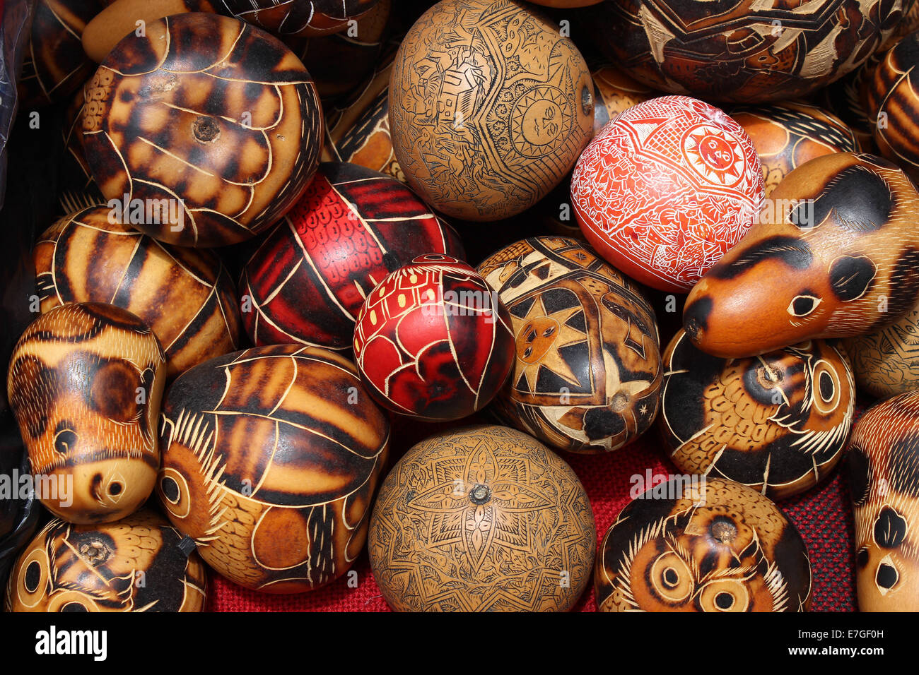 Hand carved gourds in a variety of patterns and colors for sale at the ...