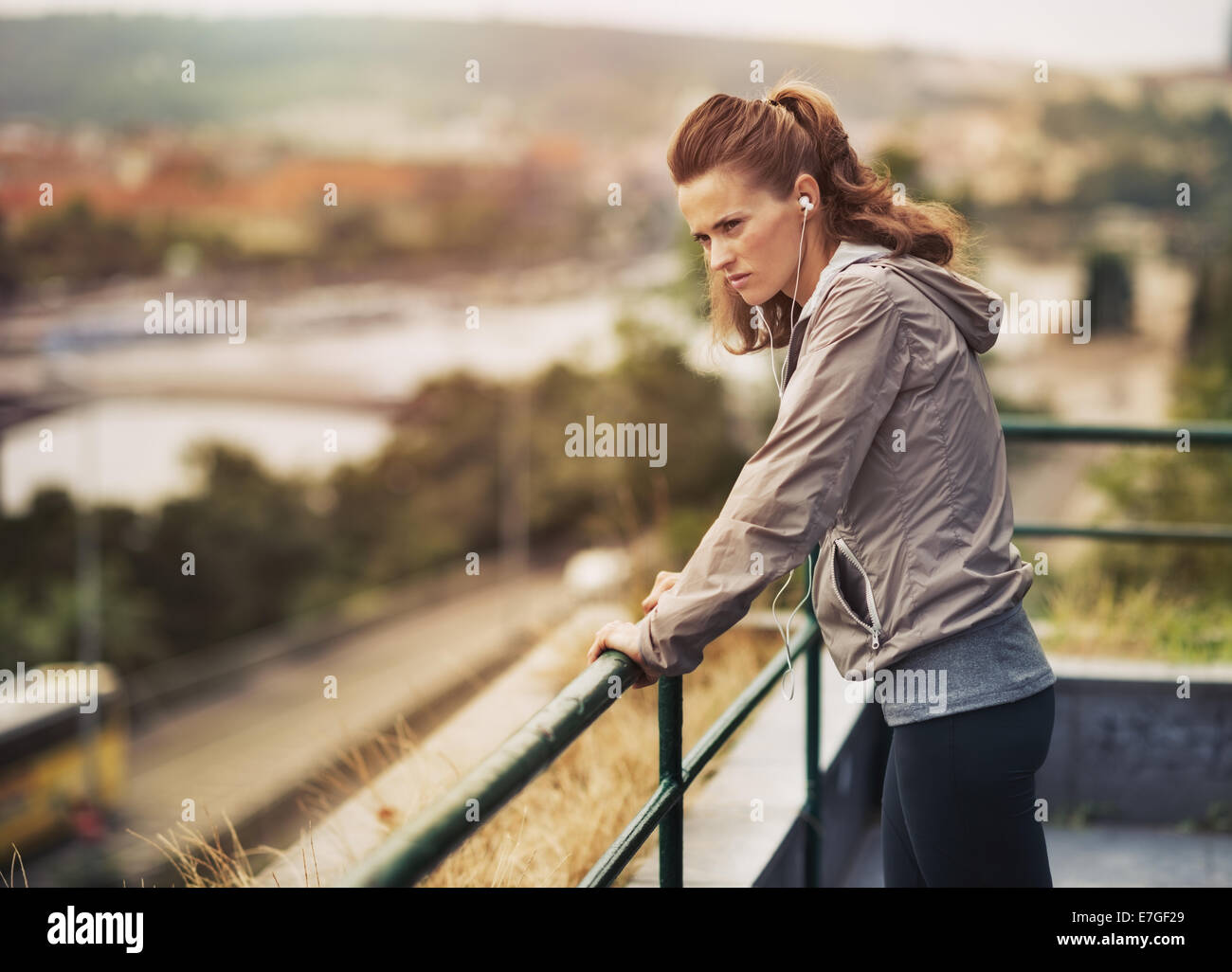 Fitness young woman looking into distance outdoors Stock Photo - Alamy