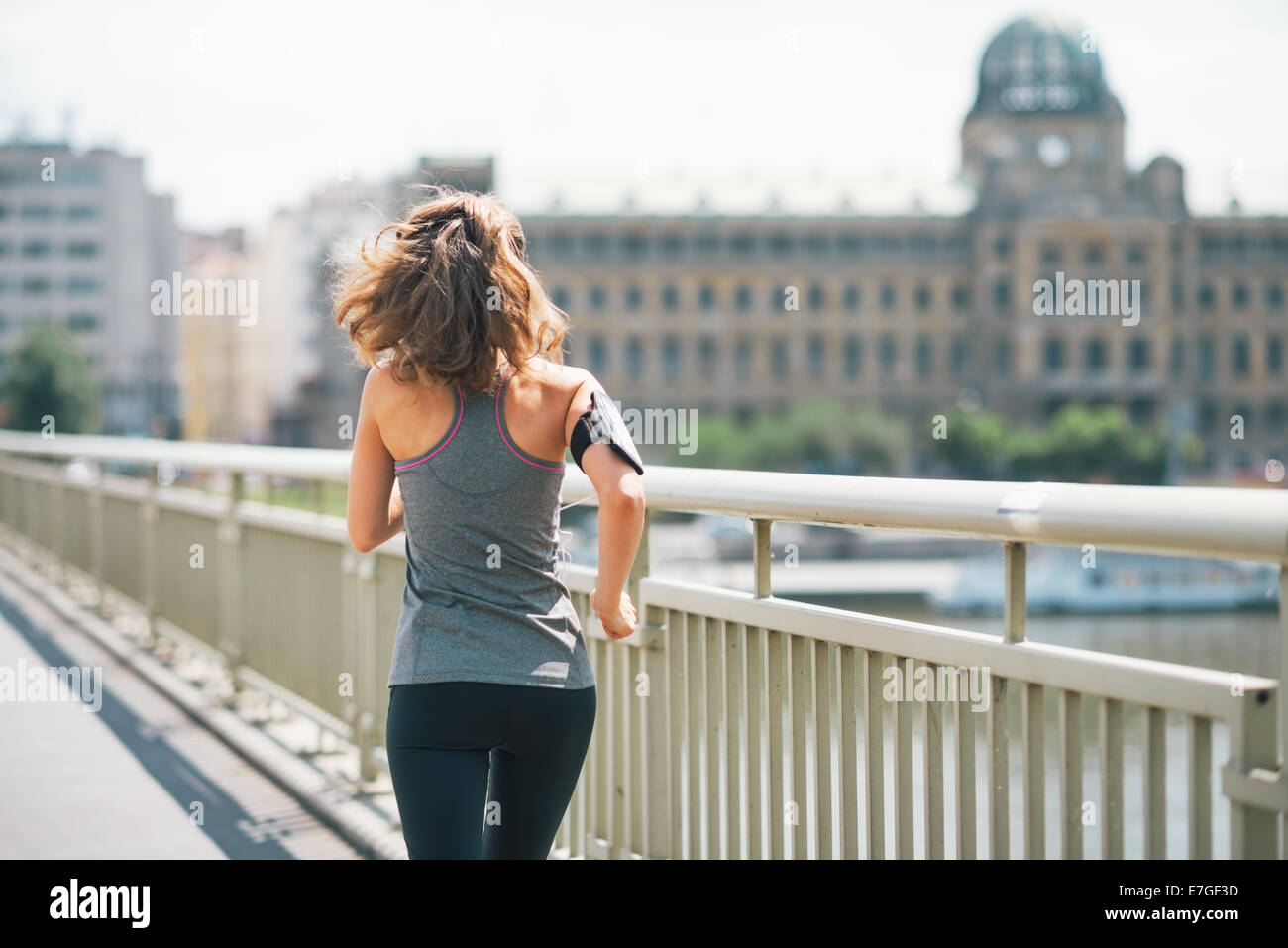 Fitness young woman jogging in the city. rear view Stock Photo - Alamy