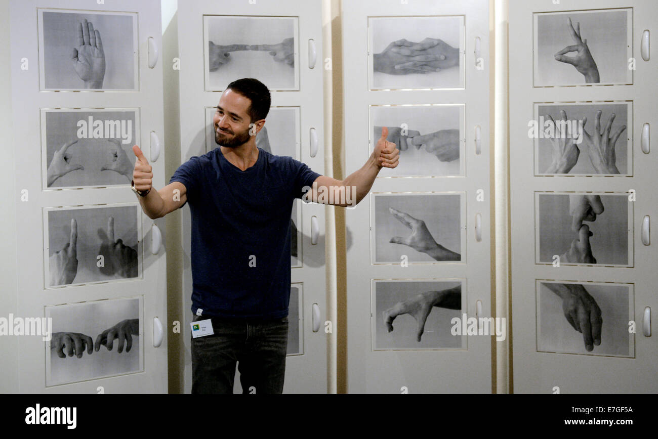 Exhibition guide Golan explains sign language expressions to visitors ...