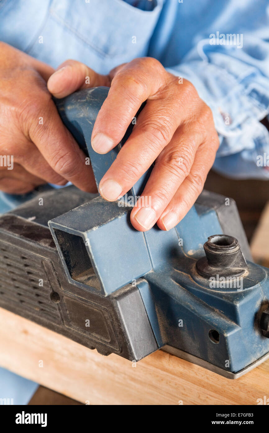 Carpenter's Hands Shaving Wood With Electric Planer Stock Photo - Alamy