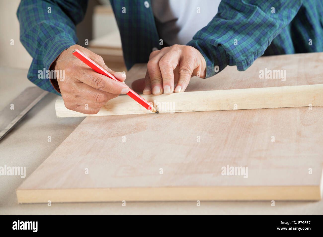 Male Carpenter Marking On Wood With Pencil Stock Photo - Alamy