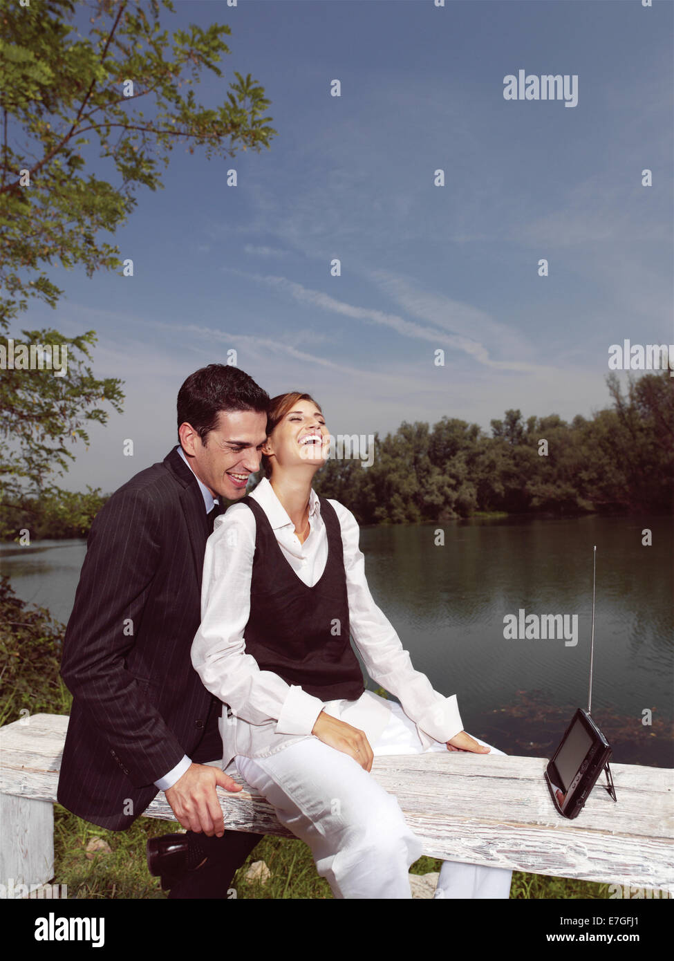 Beautiful young people using PDA outdoors Stock Photo - Alamy