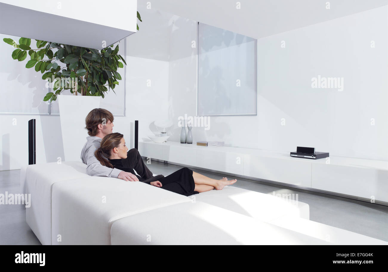 Rear view of couple sitting home hi-res stock photography and images ...