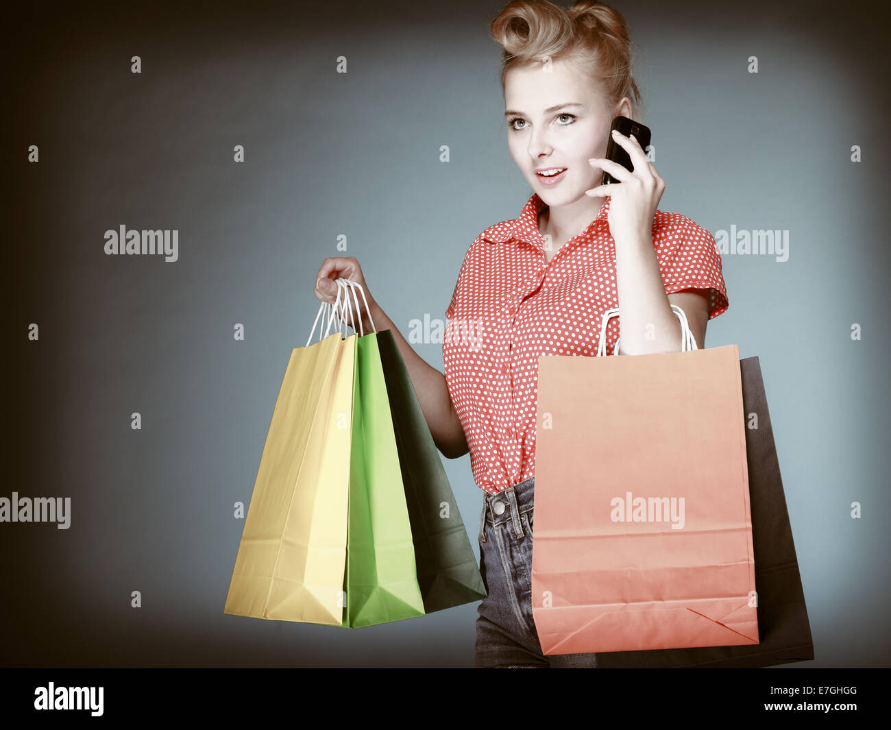 Pinup blond girl young woman in retro style buying clothes calling on ...