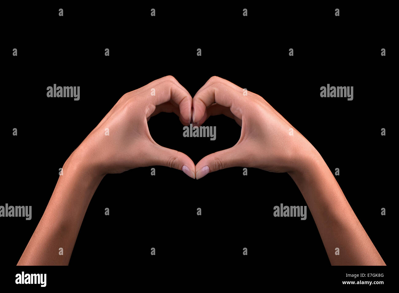 Girl hand in heart isolated on black background Stock Photo - Alamy