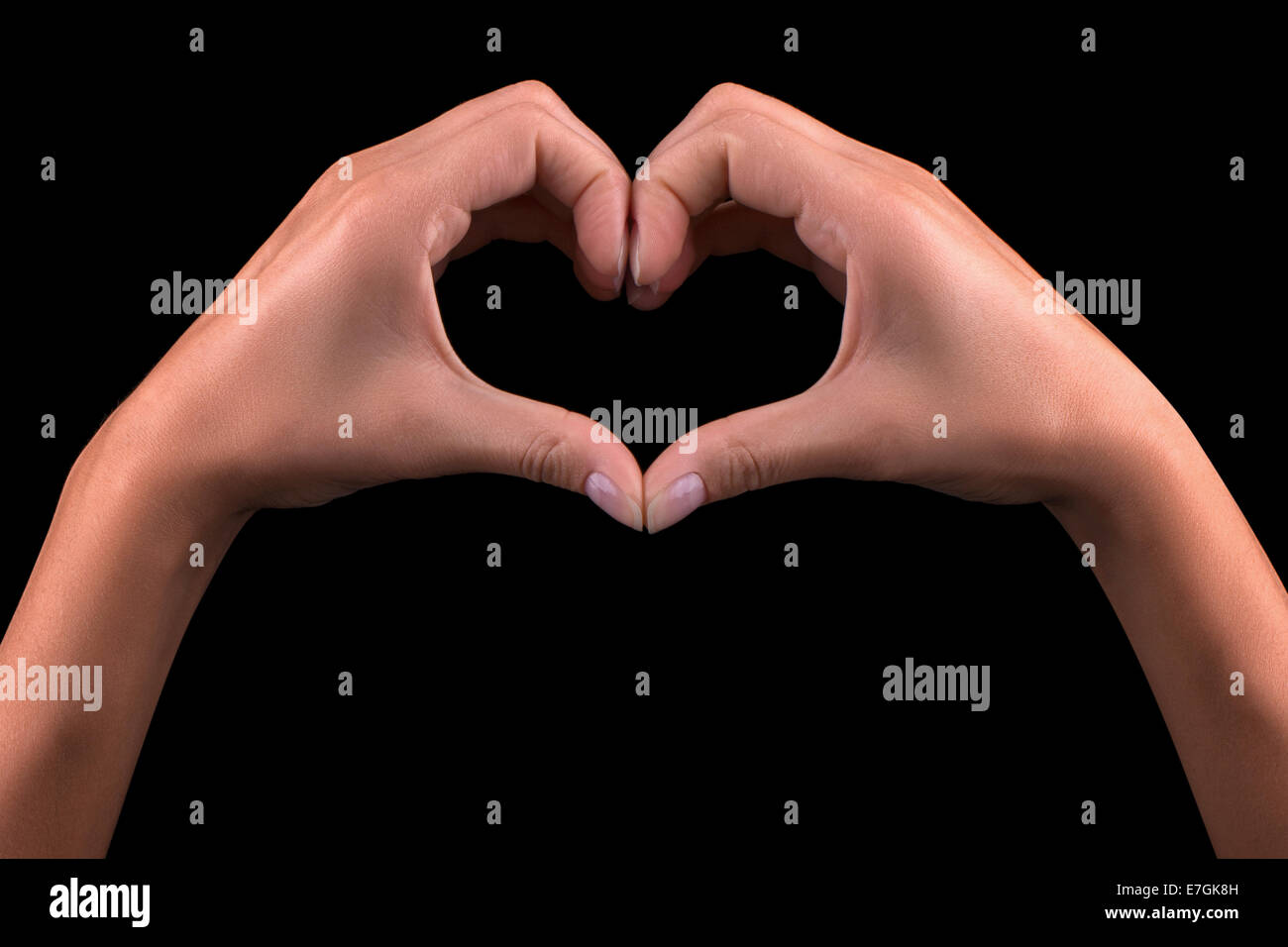 Girl hand in heart isolated on black background Stock Photo - Alamy