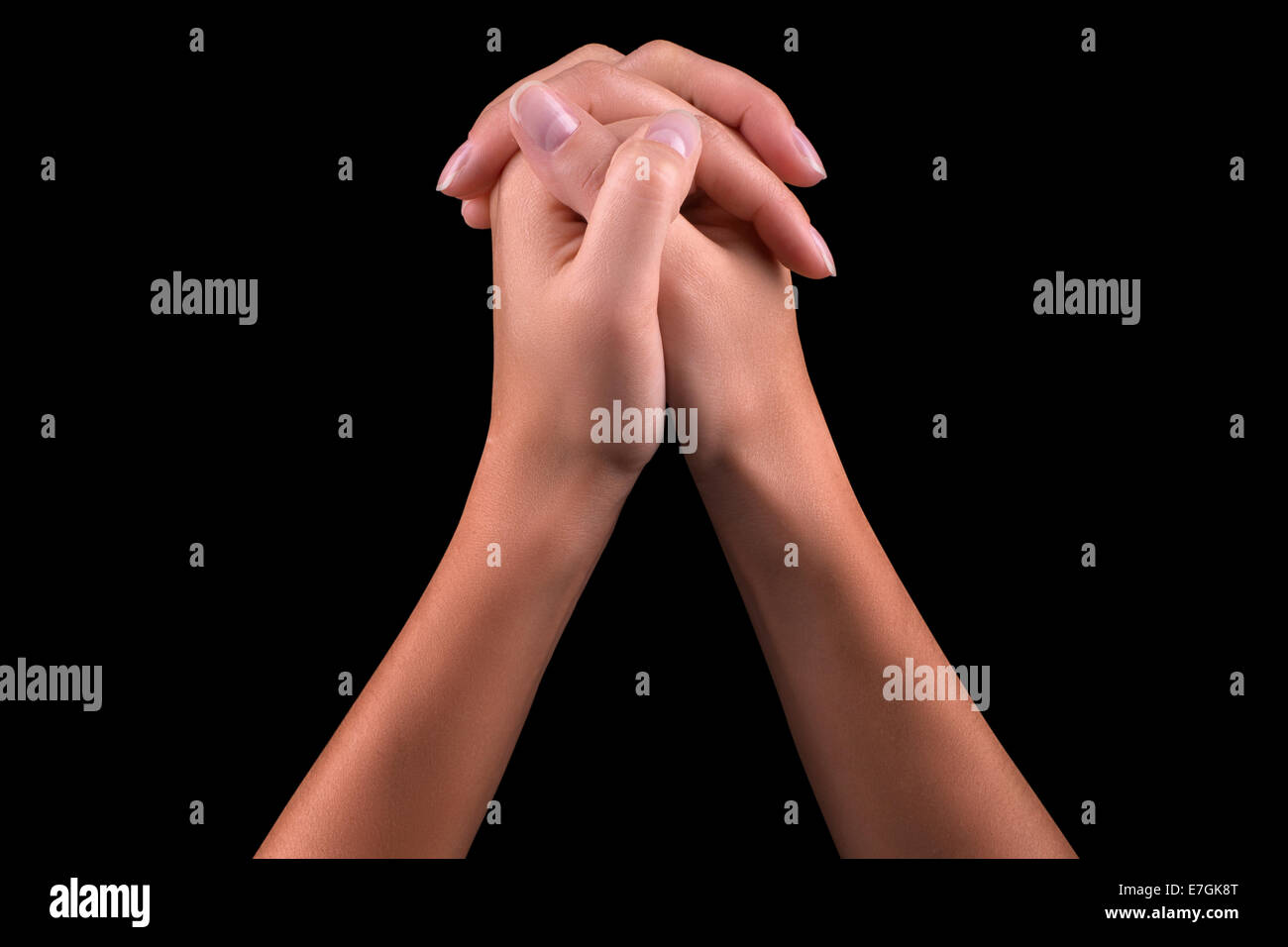 Two hands isolated on a black background, praying Stock Photo - Alamy