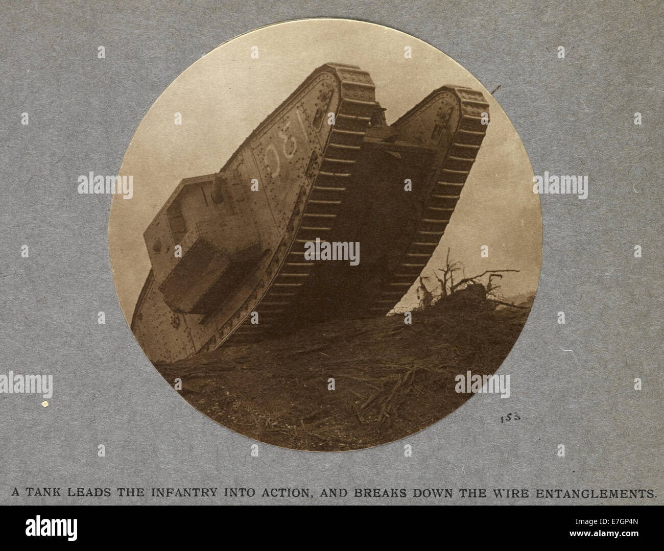 A tank leads infantry during the battle, breaking down wire ...