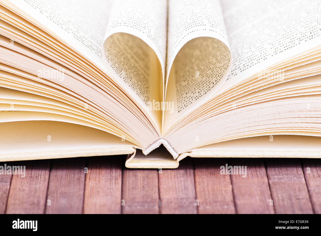 Close-up shot of an open book with two pages forming a heart Stock ...