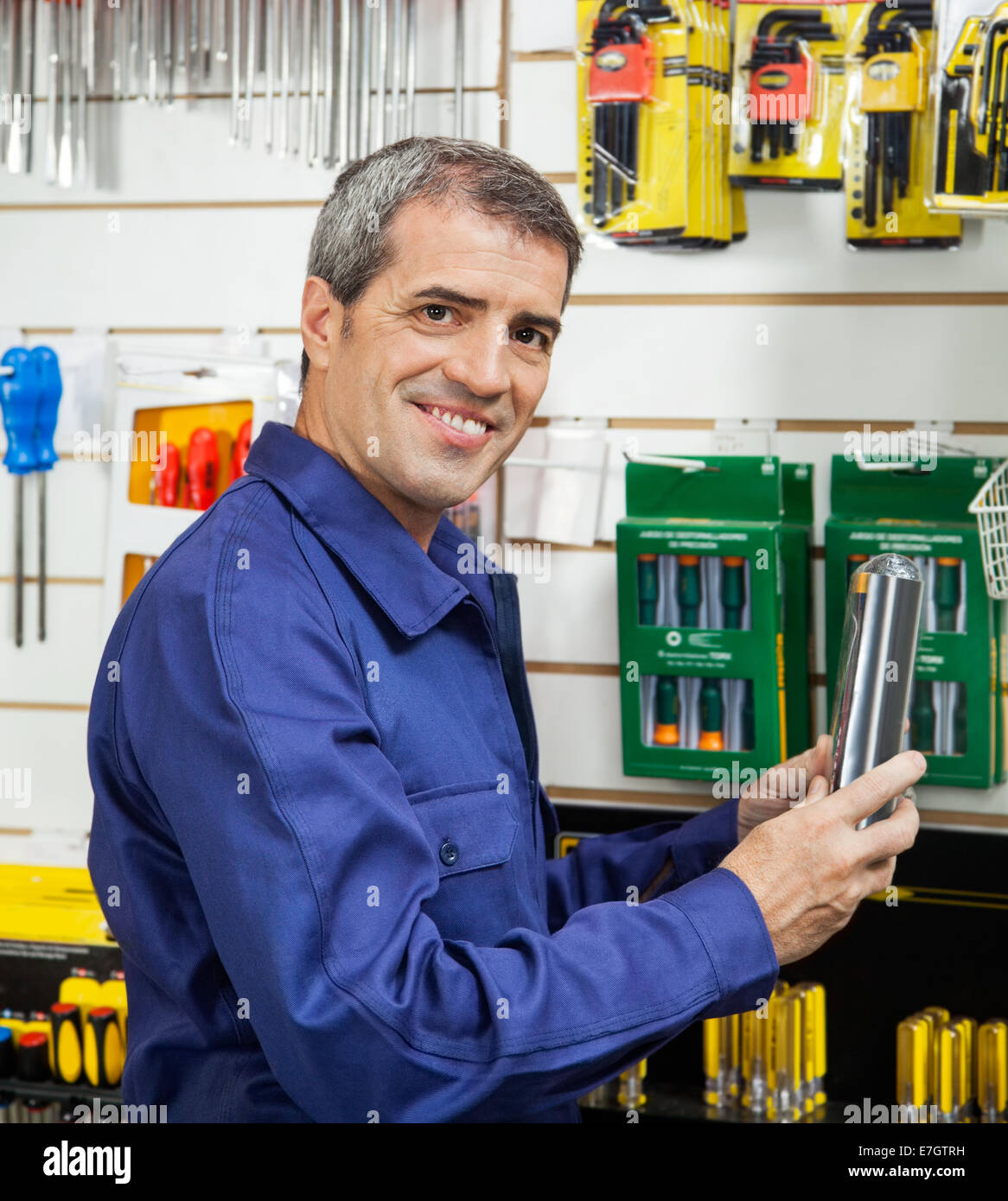 Worker Holding Packed Product In Hardware Store Stock Photo - Alamy