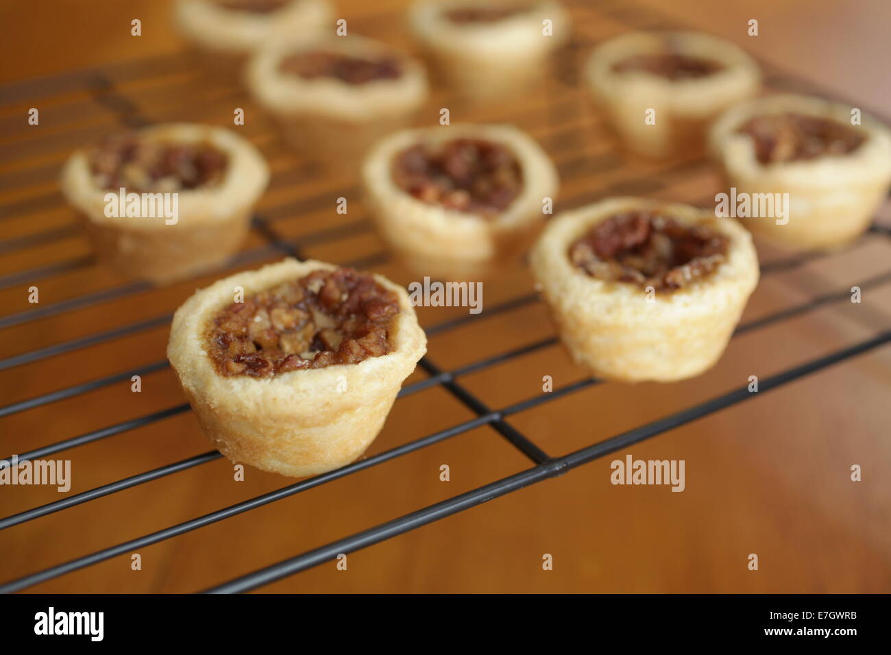 mini pecan tarts on a cooling rack Stock Photo - Alamy