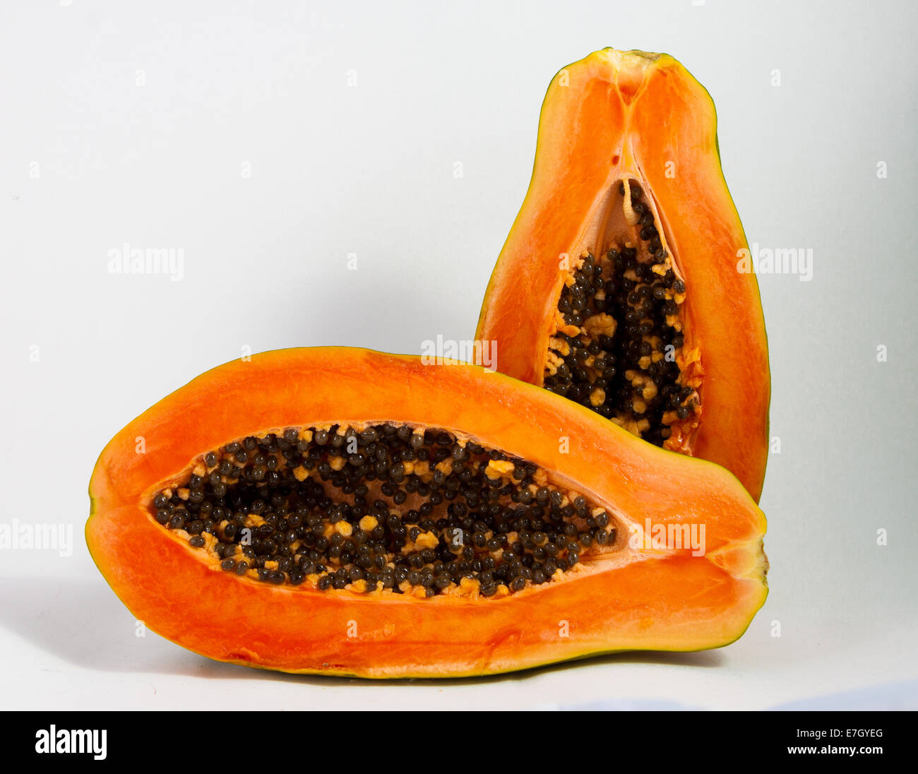 Two sliced papayas Stock Photo - Alamy