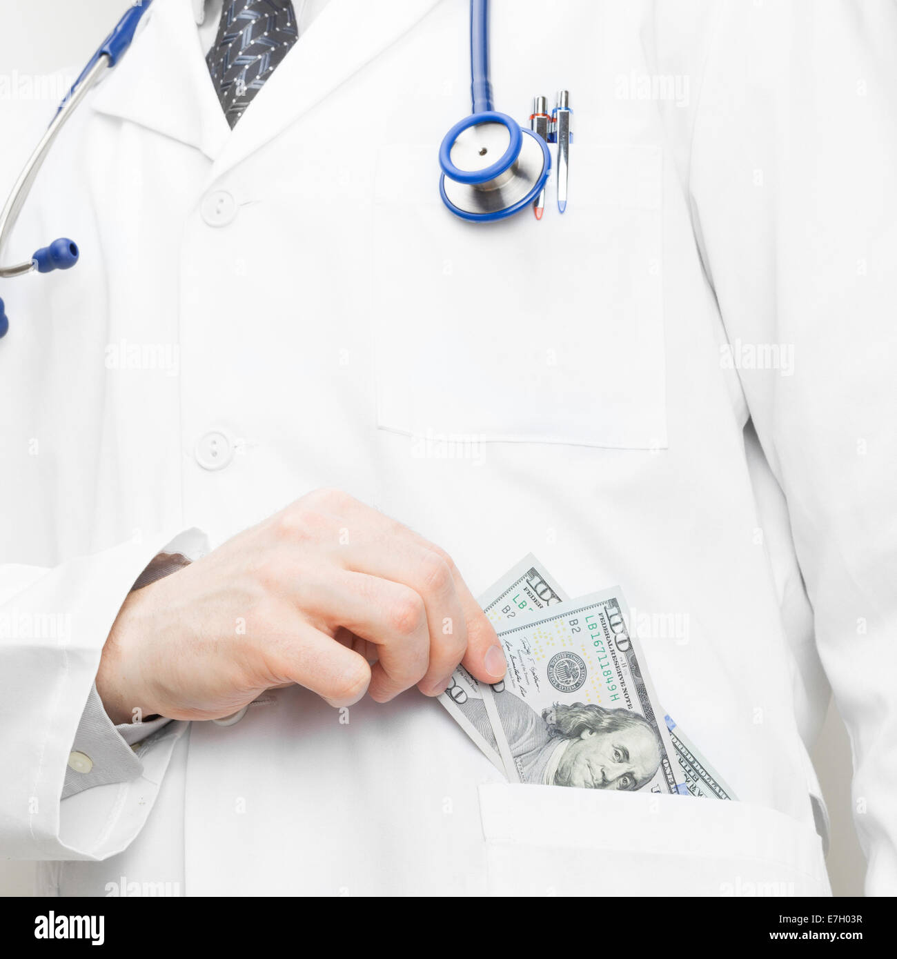 Doctor putting money into his pocket - 1 to 1 ratio Stock Photo - Alamy