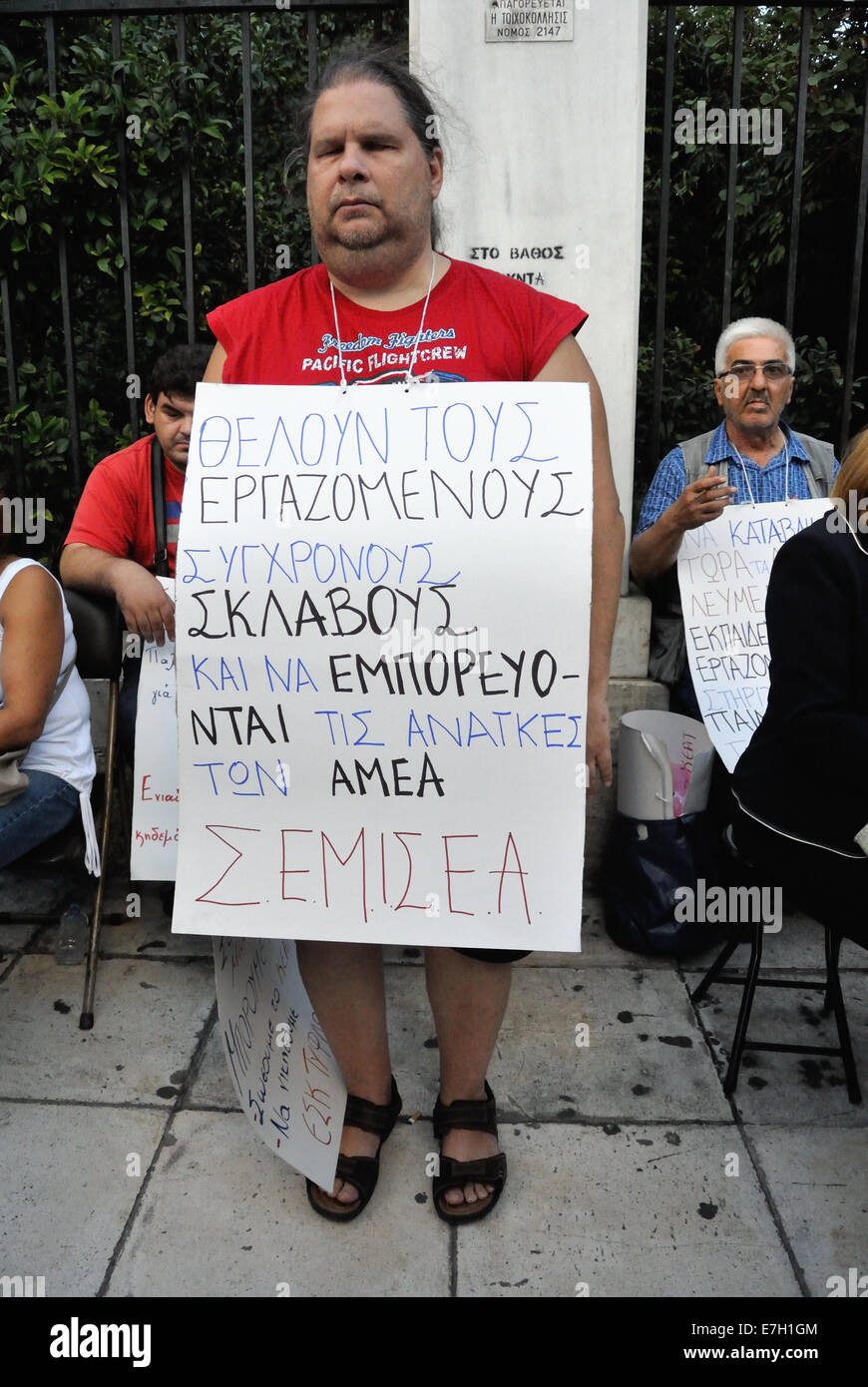Athens, Greece. 17th September, 2014. A blind man holds a placard that ...