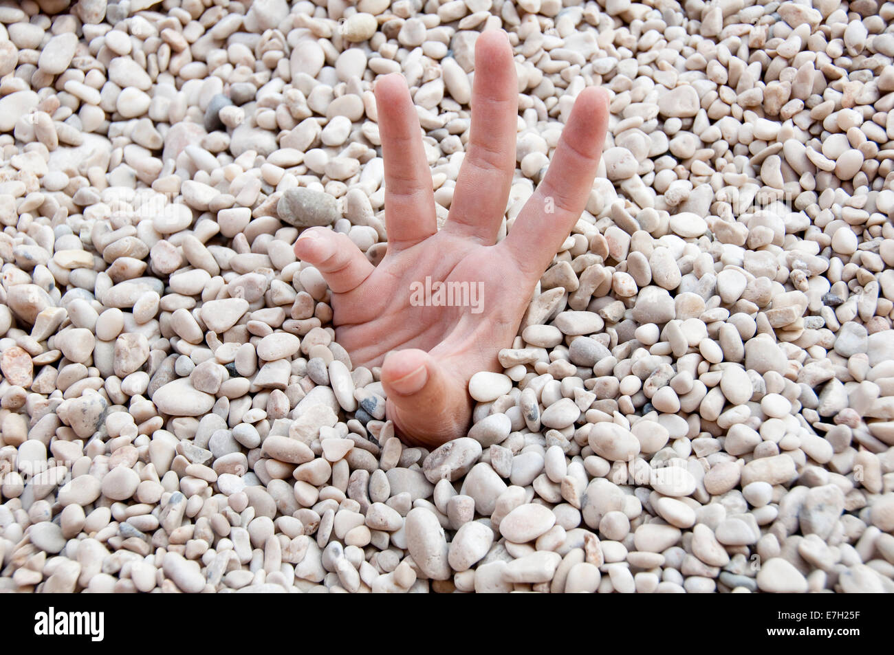 Hand out of tiny pebbles Stock Photo - Alamy