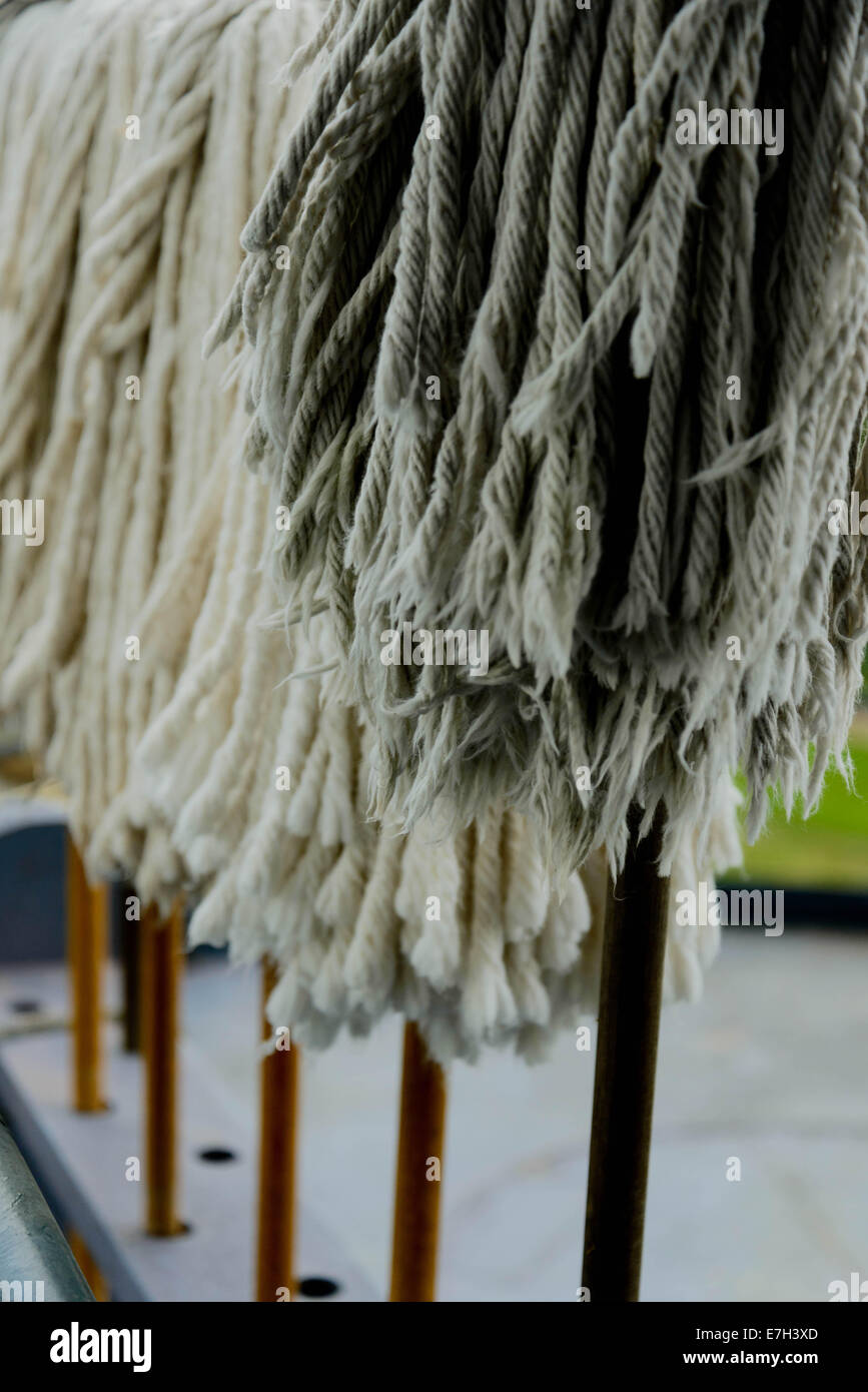 row of cleaning mops Stock Photo - Alamy