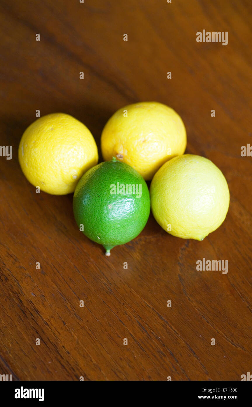 Green and yellow Tahitian limes on a wood surface Stock Photo - Alamy