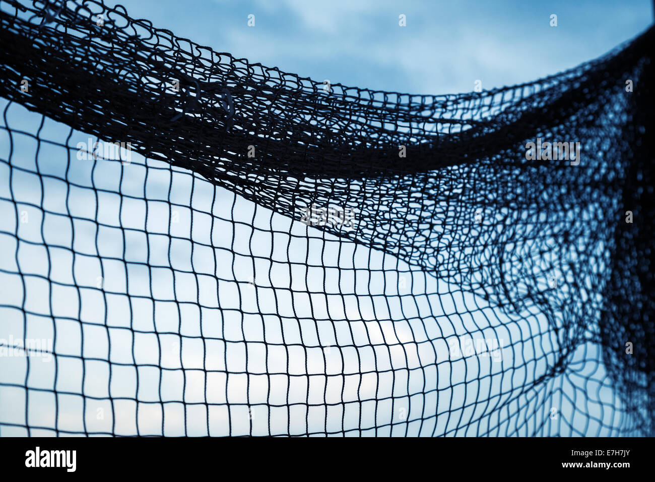Fishing net silhouette above blue sky background Stock Photo - Alamy