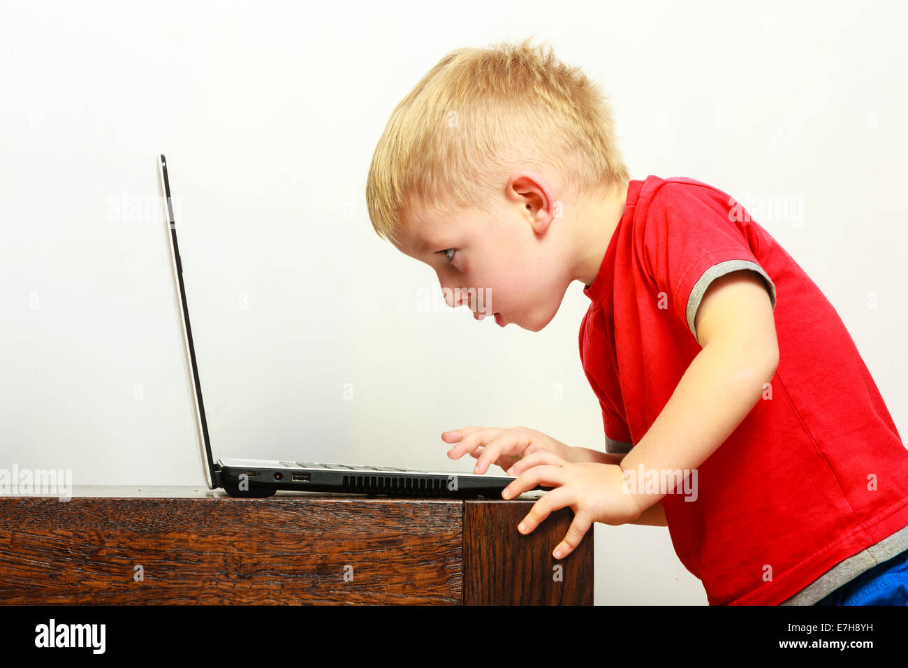 Children, technology and home concept - little boy kid child using ...