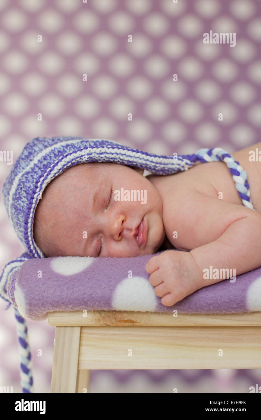 Baby girl, sleeping on a chair Stock Photo - Alamy