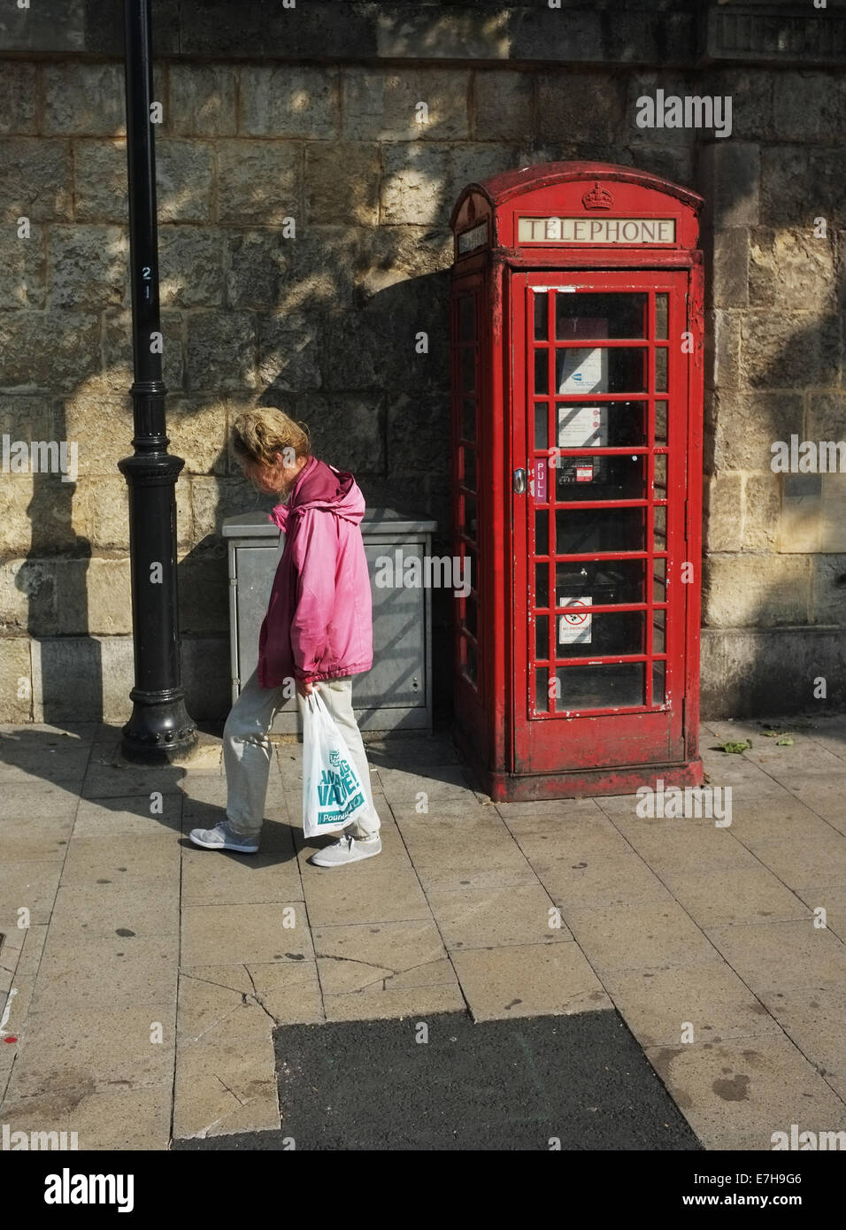 Homeless lady walking poverty telephone box hi-res stock photography ...