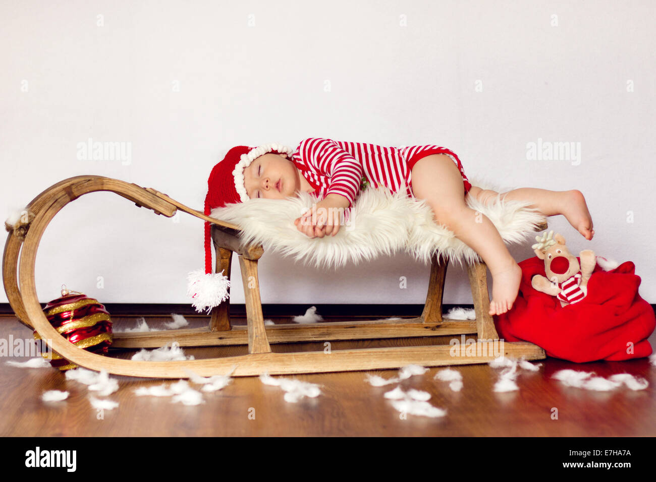Little baby boy, sleeping on a sled Stock Photo - Alamy